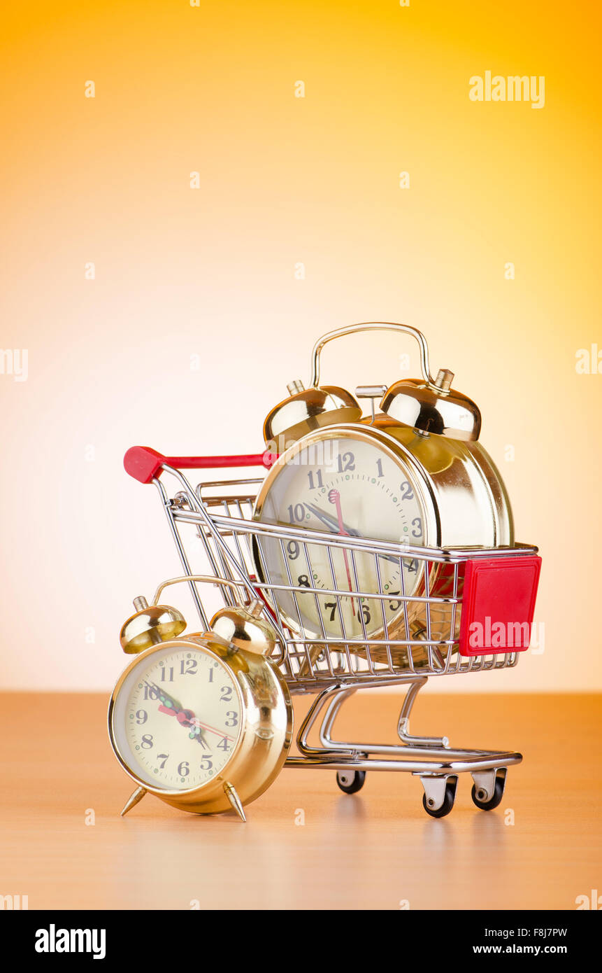 Buying time concept with clock and shopping cart Stock Photo - Alamy