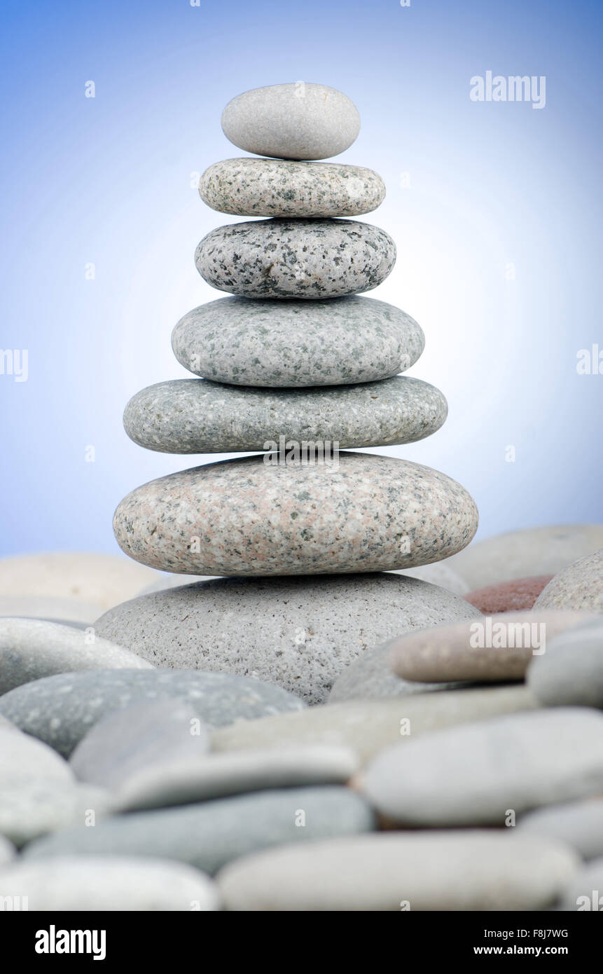Pebbles stack against gradient background Stock Photo - Alamy