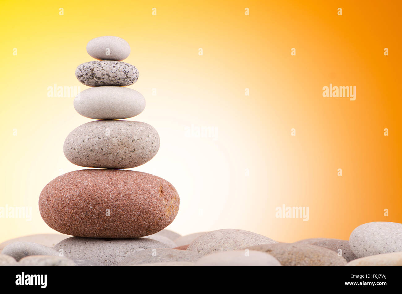 Pebbles stack against gradient background Stock Photo - Alamy