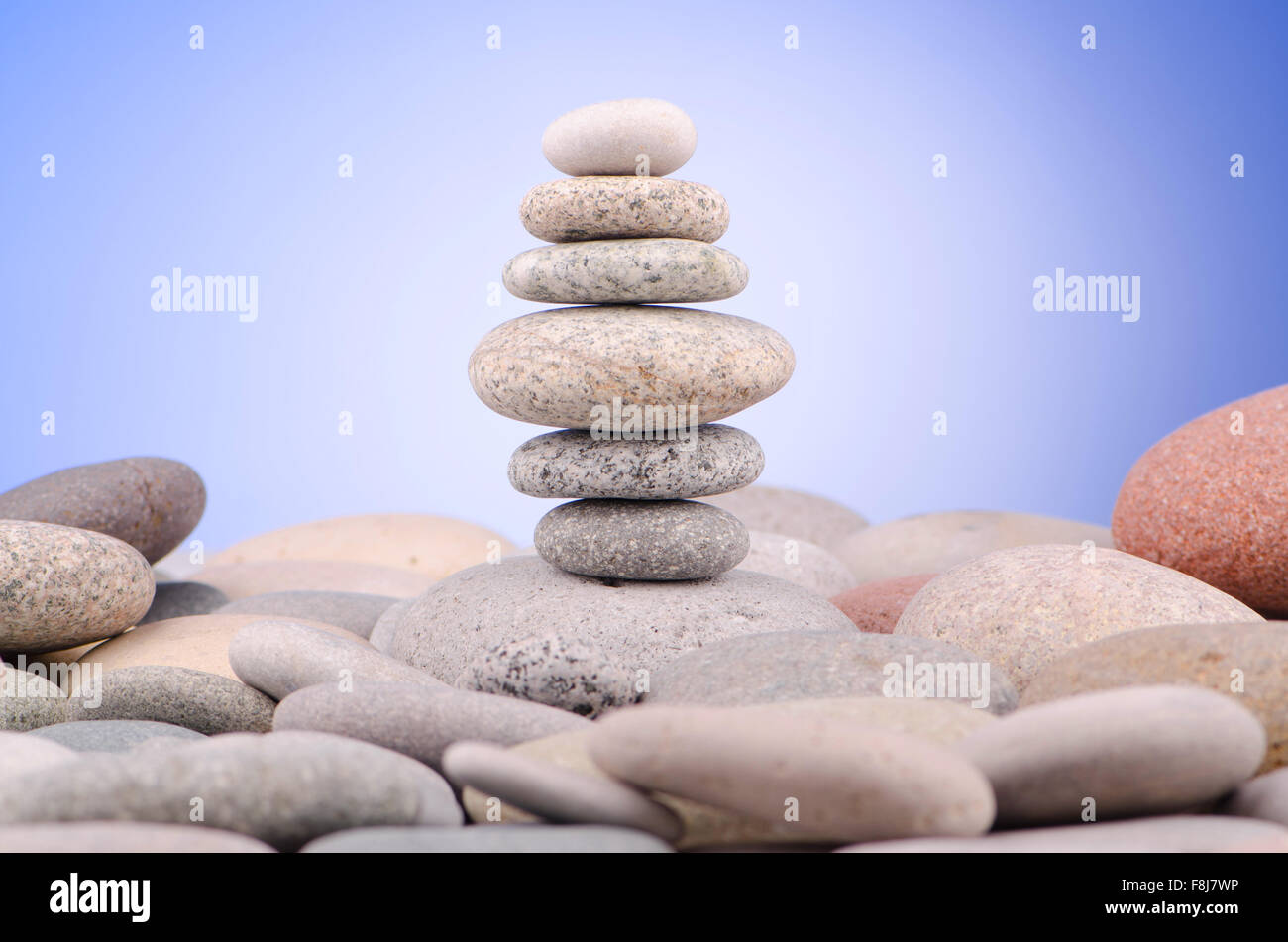 Pebbles stack against gradient background Stock Photo - Alamy