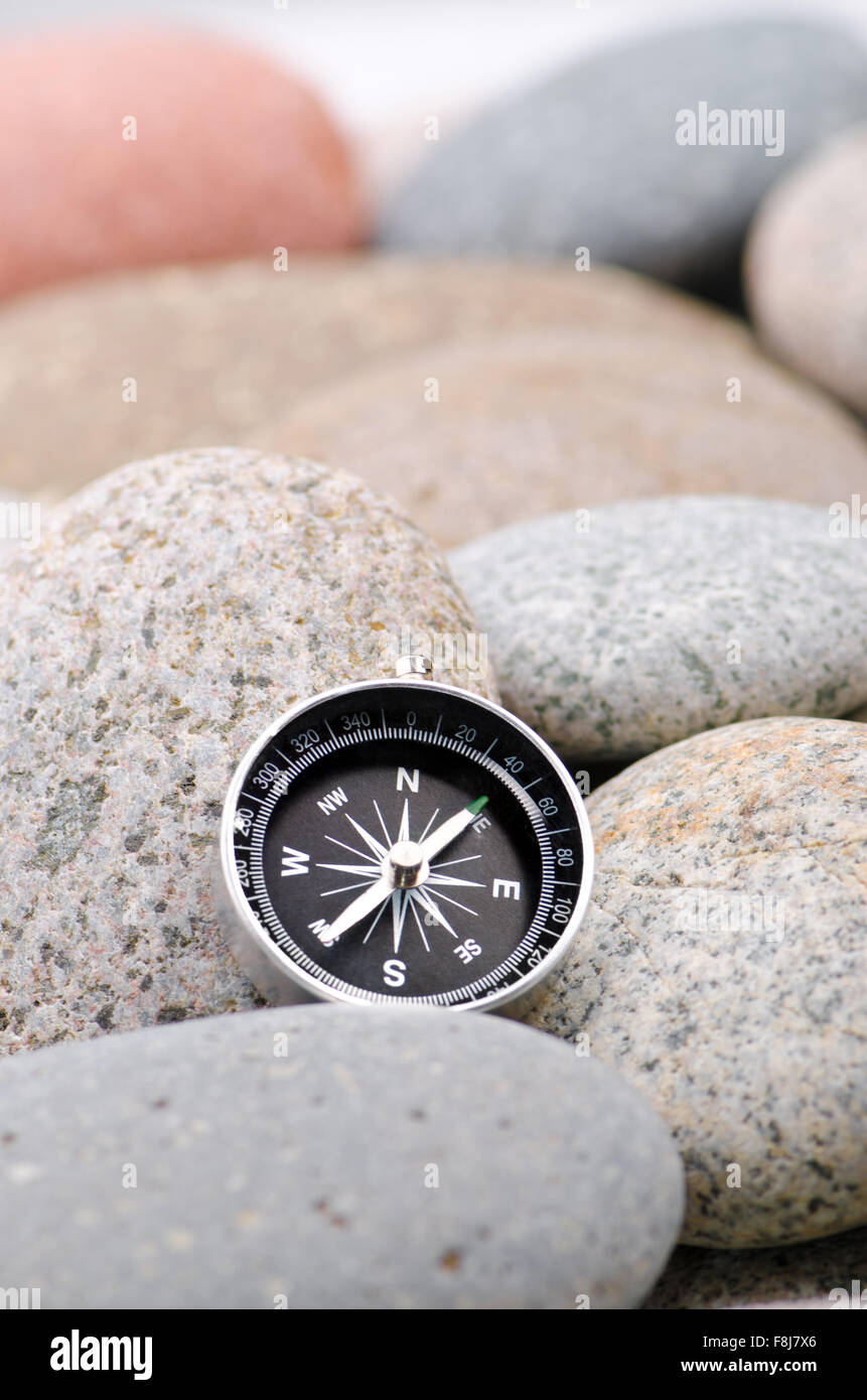 Navigation compass on stone pebbles Stock Photo - Alamy