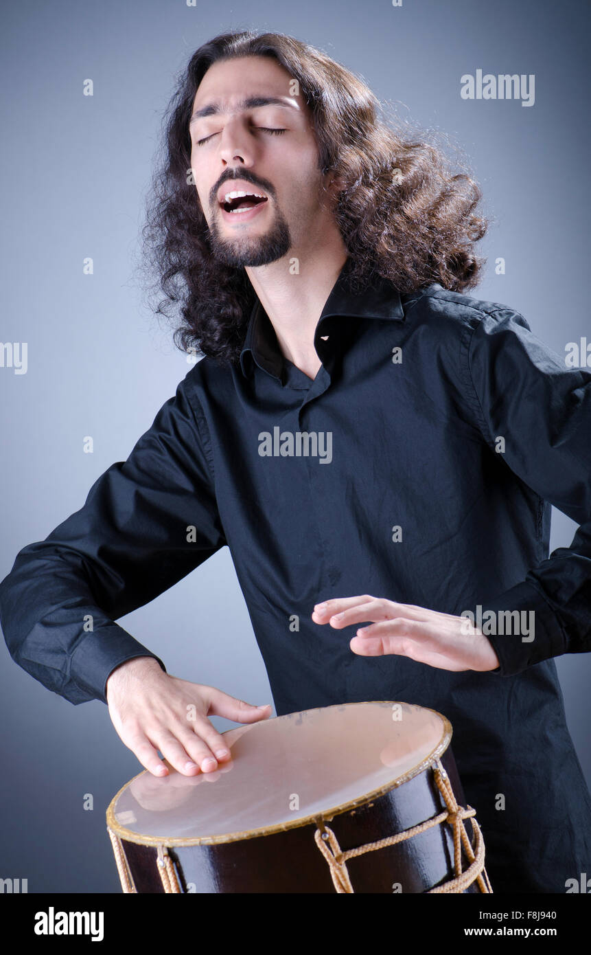 Man playing drum in studio Stock Photo - Alamy