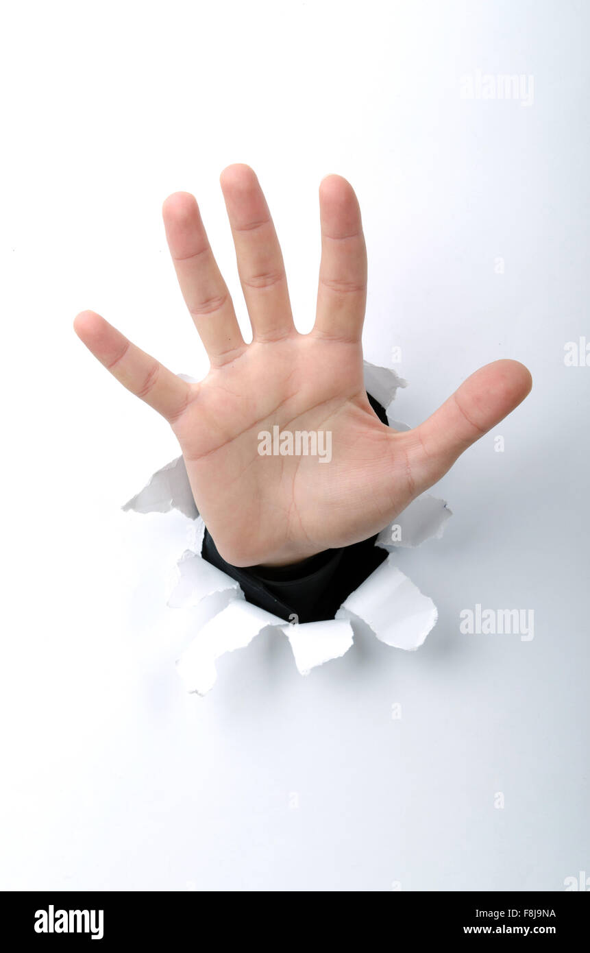 Hand through the hole in paper Stock Photo - Alamy
