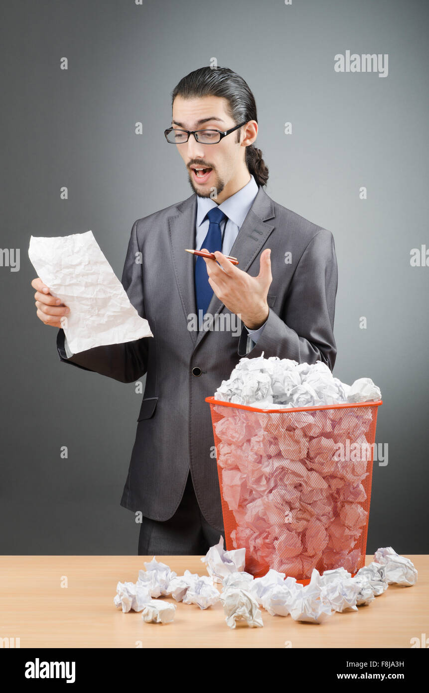 Man with lots of wasted paper Stock Photo - Alamy
