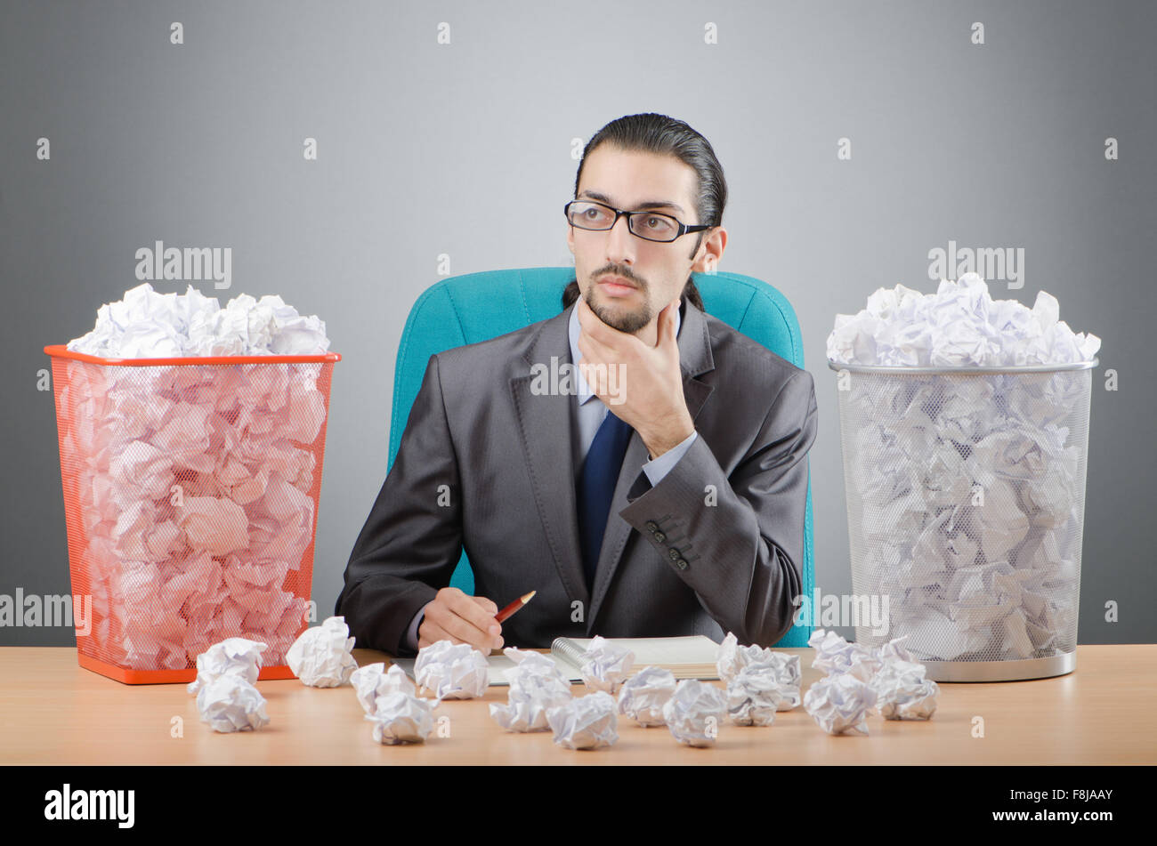Man with lots of wasted paper Stock Photo - Alamy