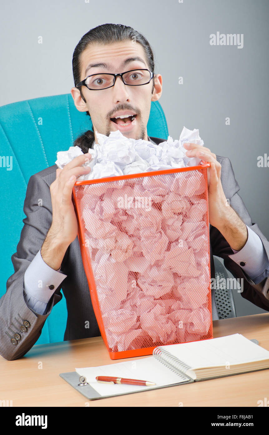 Man with lots of wasted paper Stock Photo - Alamy