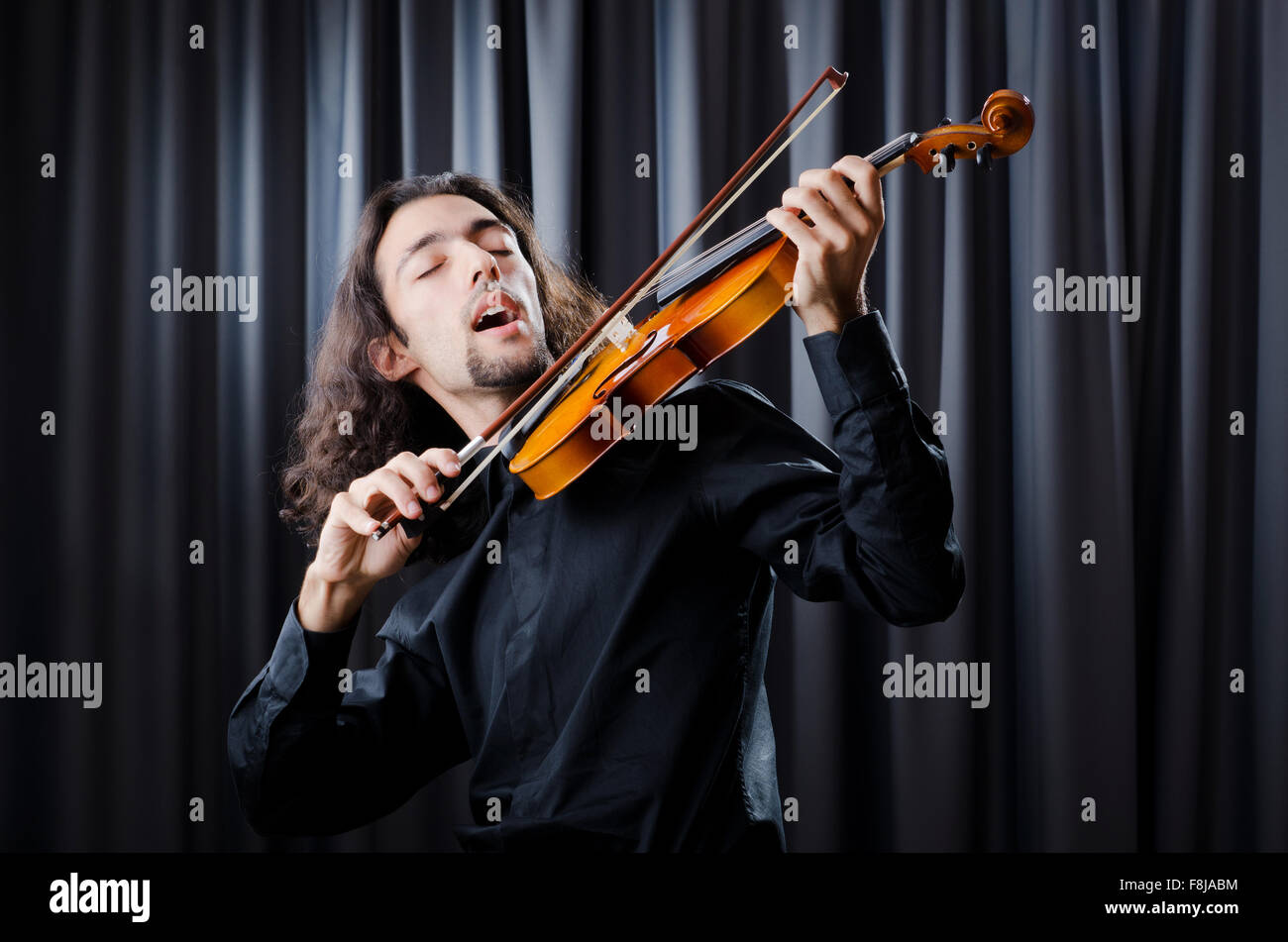 Young violin player playing Stock Photo - Alamy
