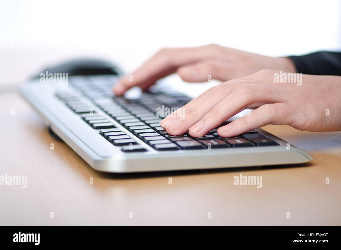 Hands typing on the keyboard Stock Photo - Alamy