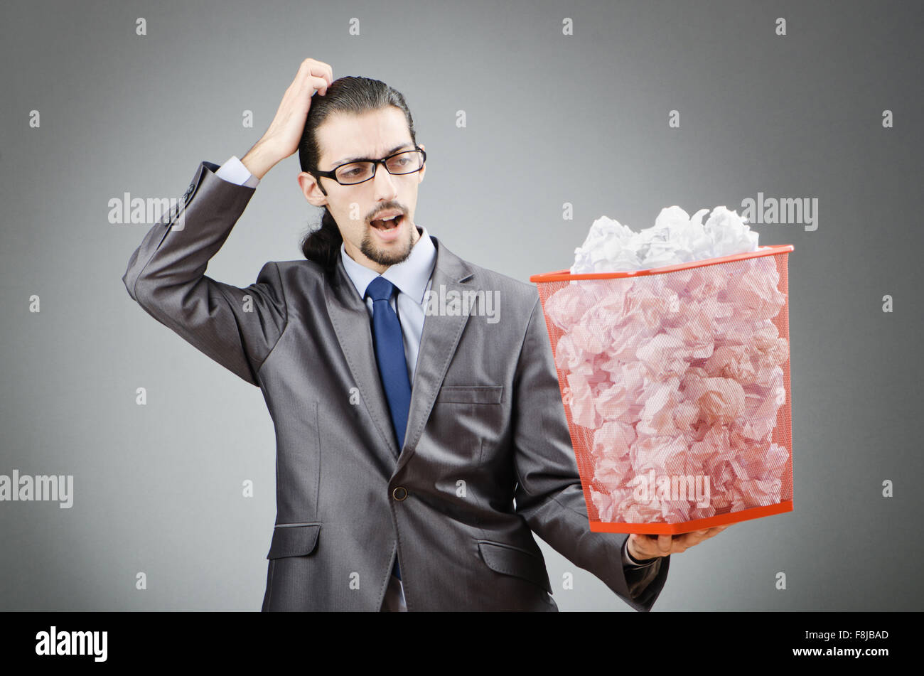 Man with lots of wasted paper Stock Photo - Alamy