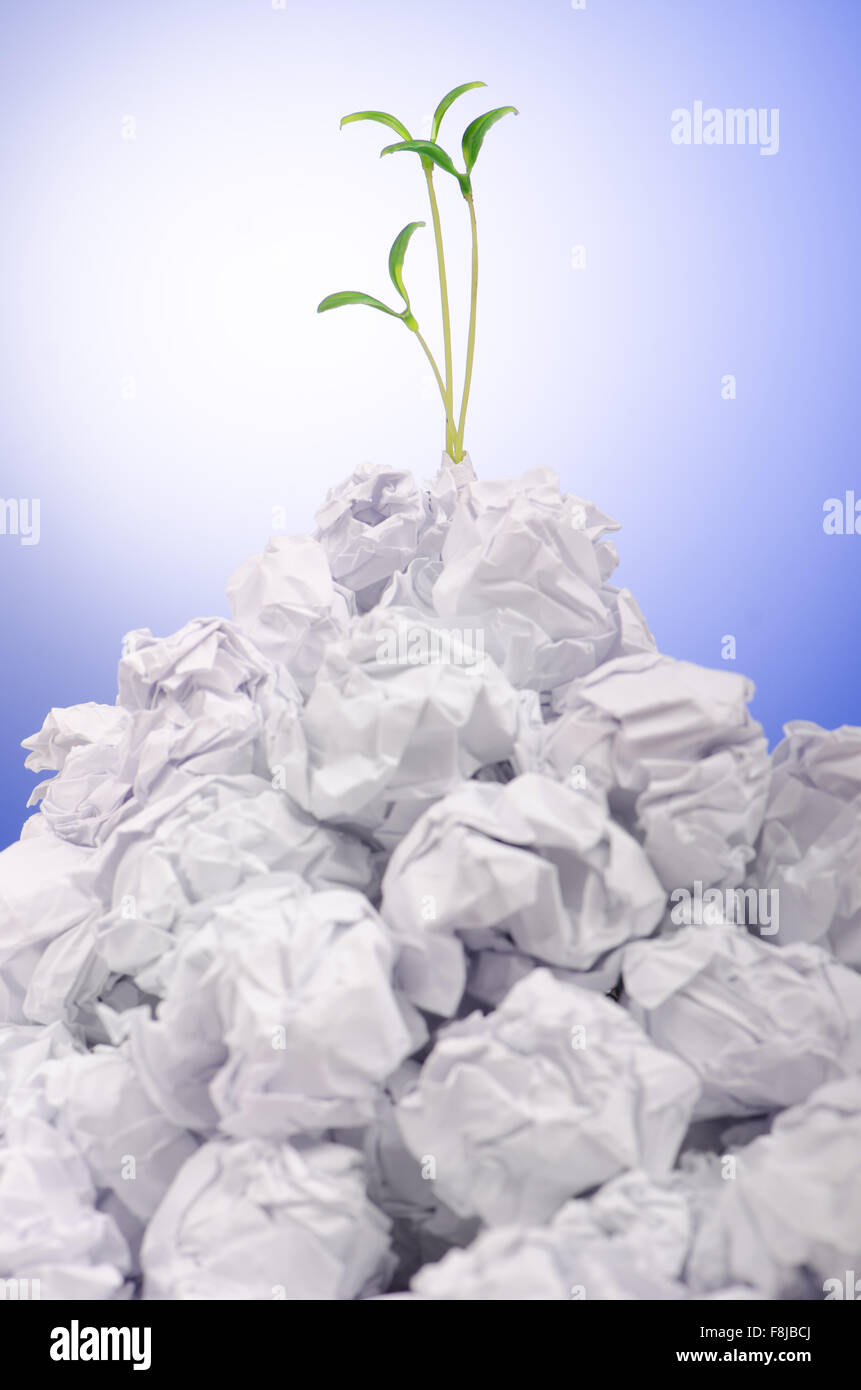 Green seedlings growing out of paper Stock Photo - Alamy