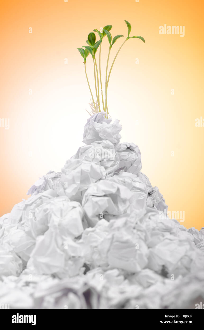 Green seedlings growing out of paper Stock Photo - Alamy