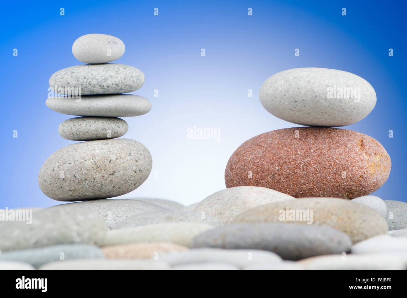 Pebbles stack against gradient background Stock Photo - Alamy