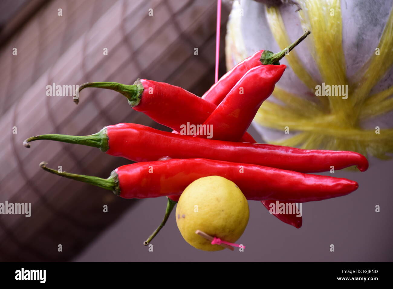 Chillies and lemon hung outside shops to ward off evil Stock Photo - Alamy