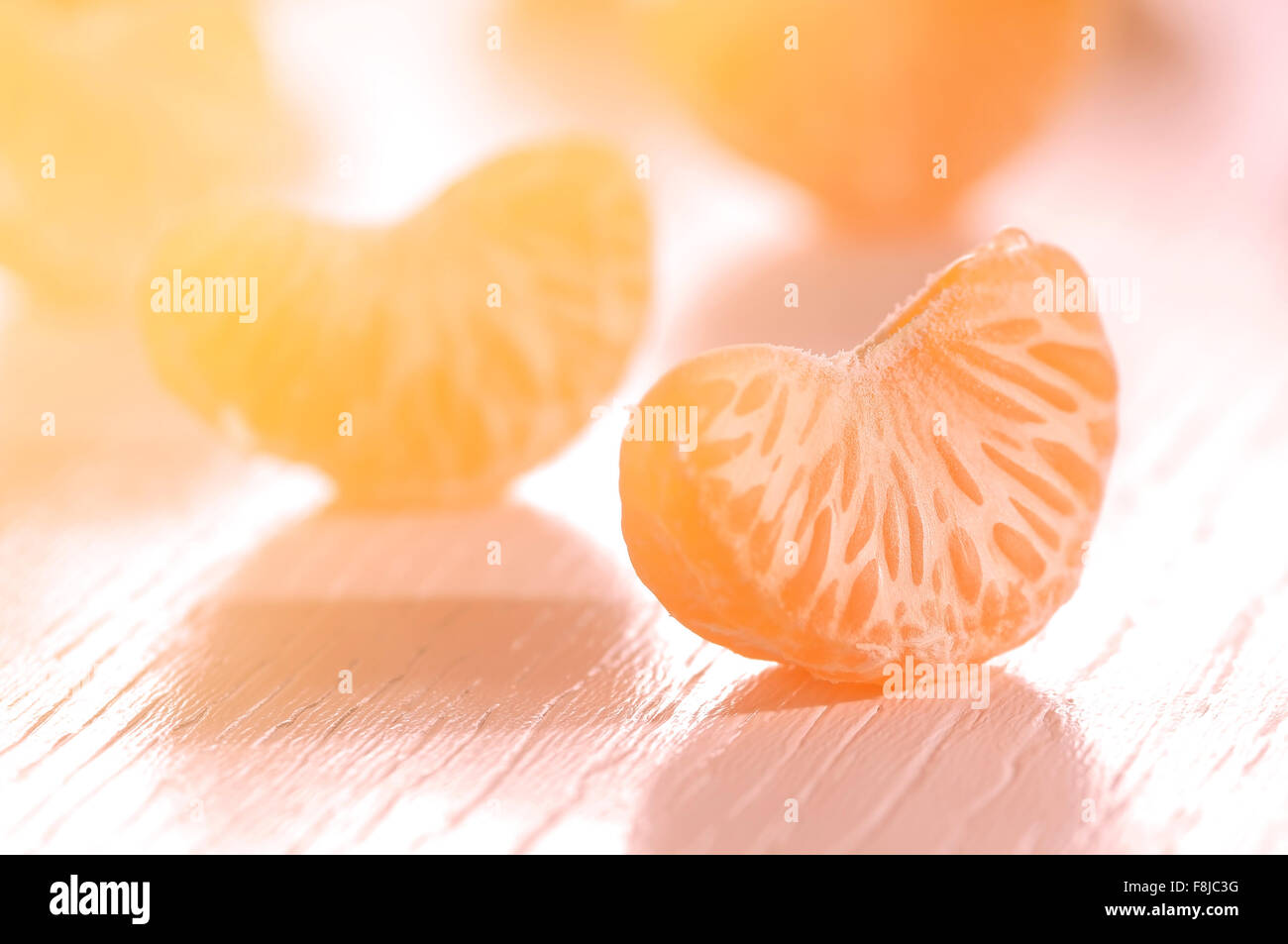 mandarin segments on a white board selective focus on first Stock Photo ...