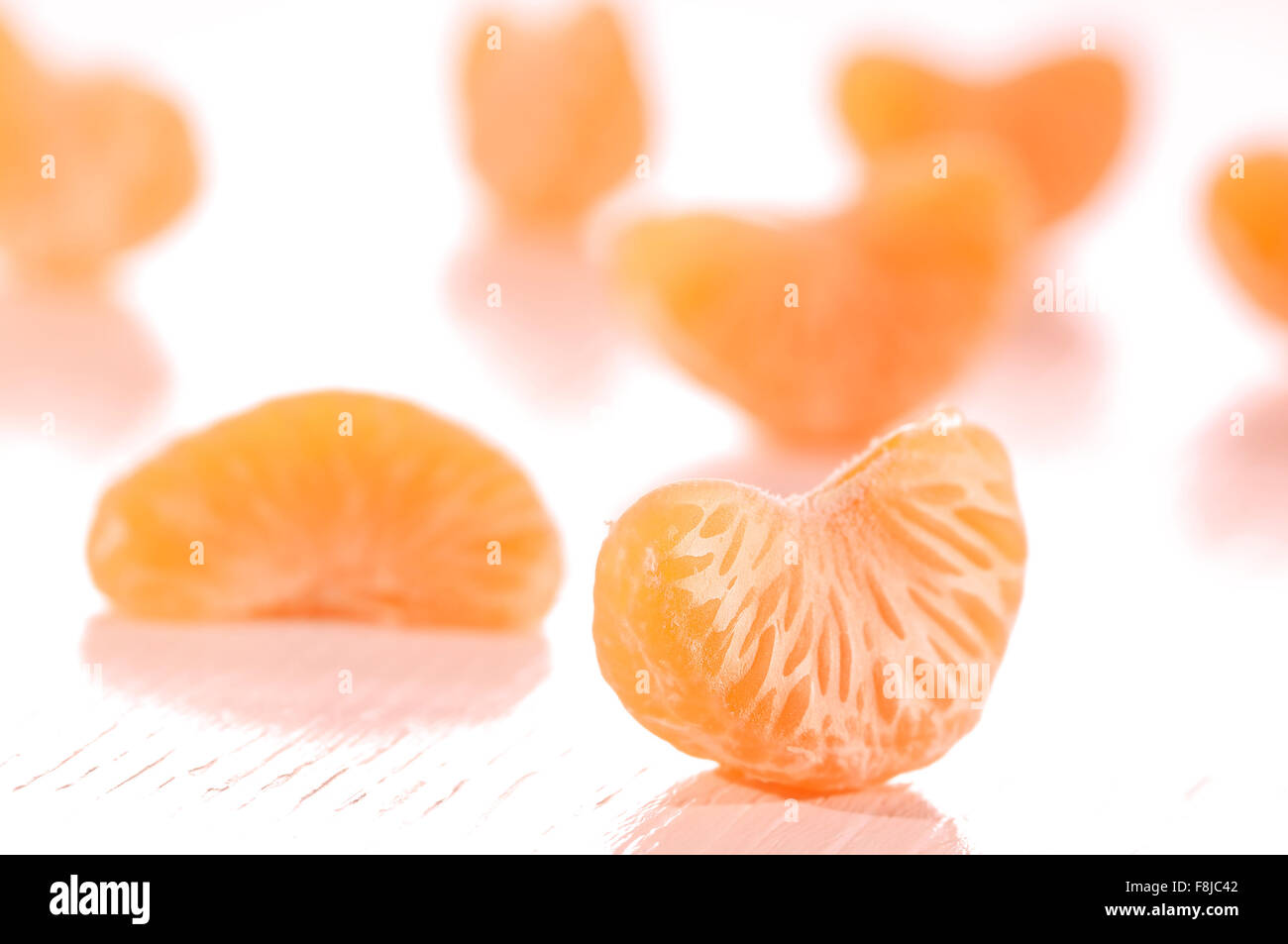 mandarin segments on a white board selective focus on first Stock Photo ...
