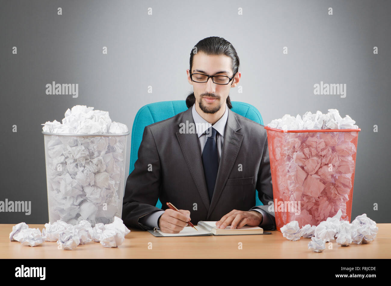 Man with lots of wasted paper Stock Photo - Alamy