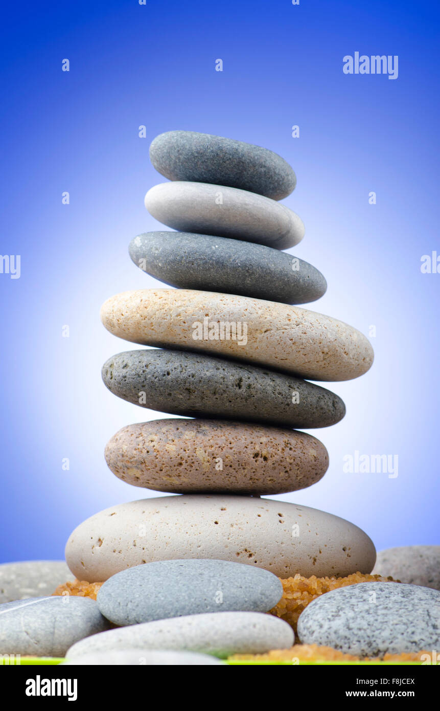 Balanced pebbles with colour background Stock Photo - Alamy
