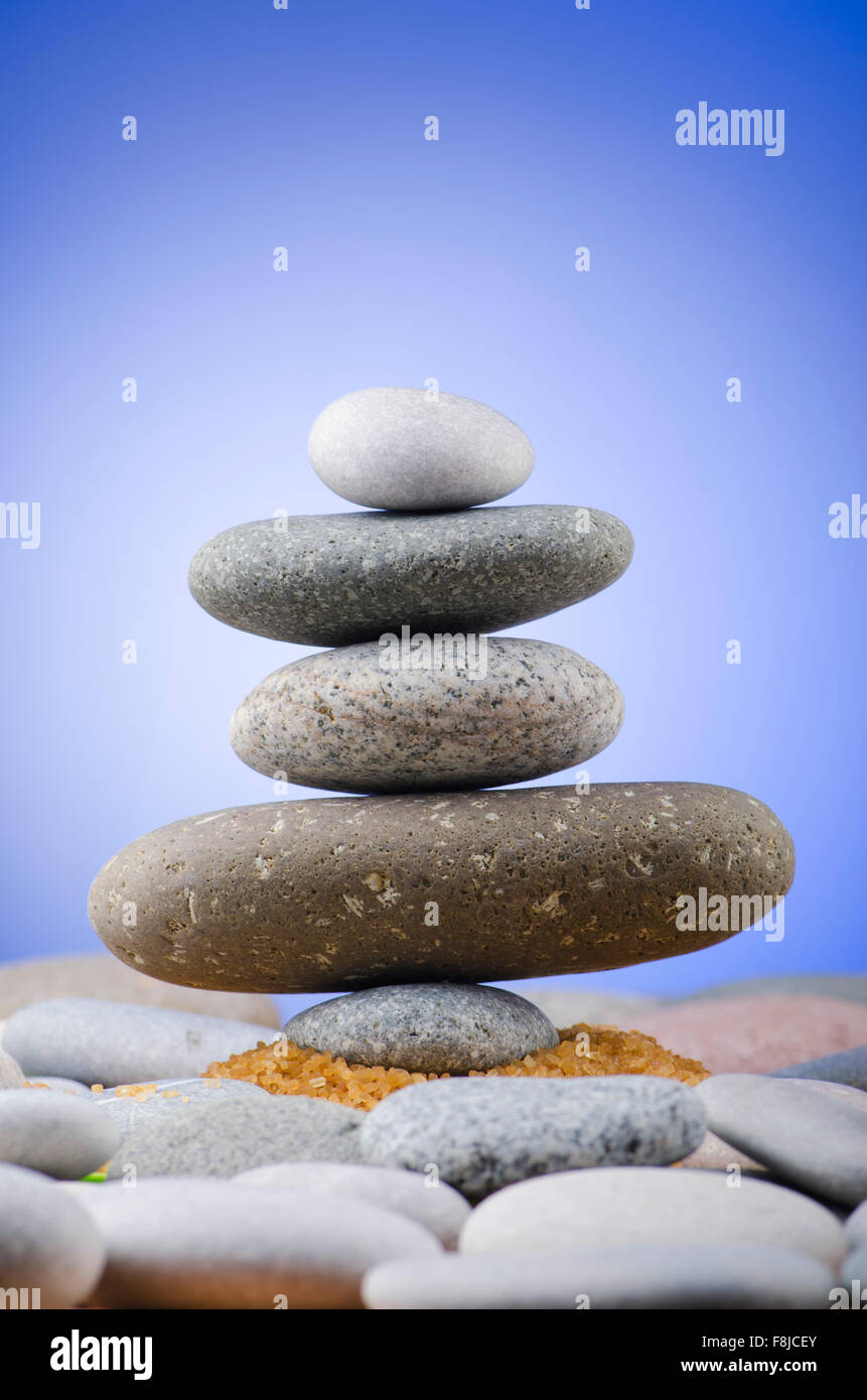 Balanced pebbles with colour background Stock Photo - Alamy