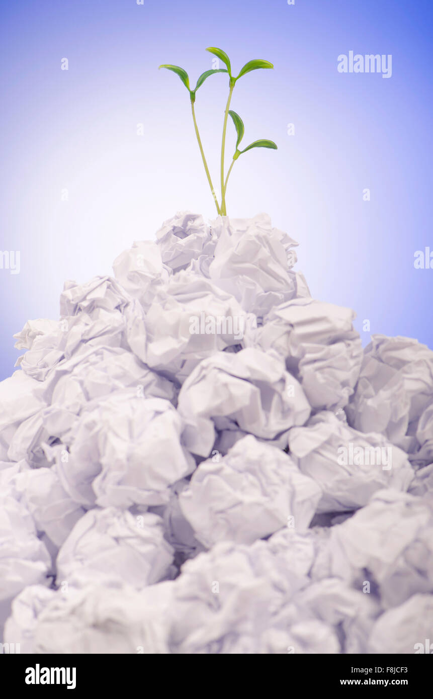Green seedlings growing out of paper Stock Photo - Alamy