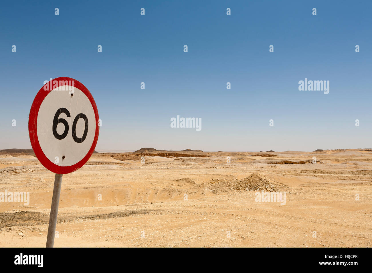 A single 60 speed restriction circular road sign with red border on a ...