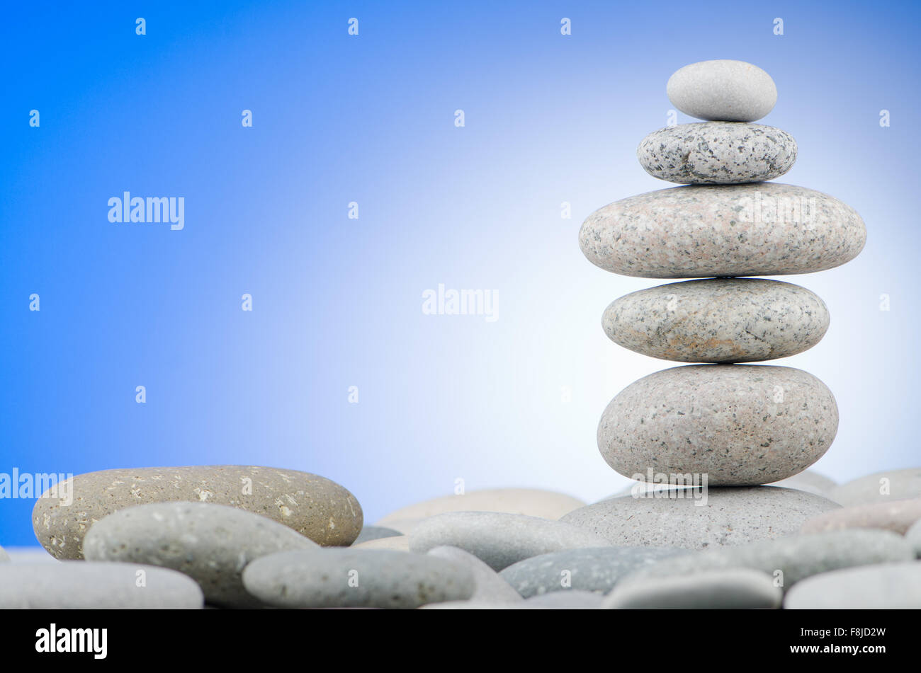 Pebbles stack against gradient background Stock Photo - Alamy