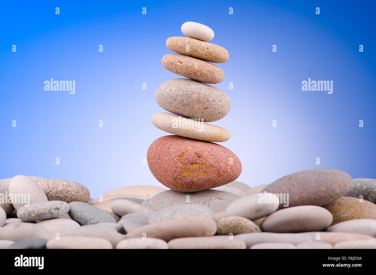 Pebbles stack against gradient background Stock Photo - Alamy