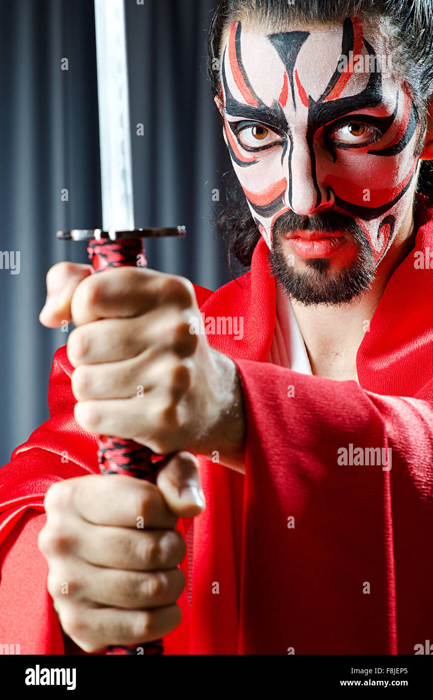 Man with face mask and sword Stock Photo - Alamy