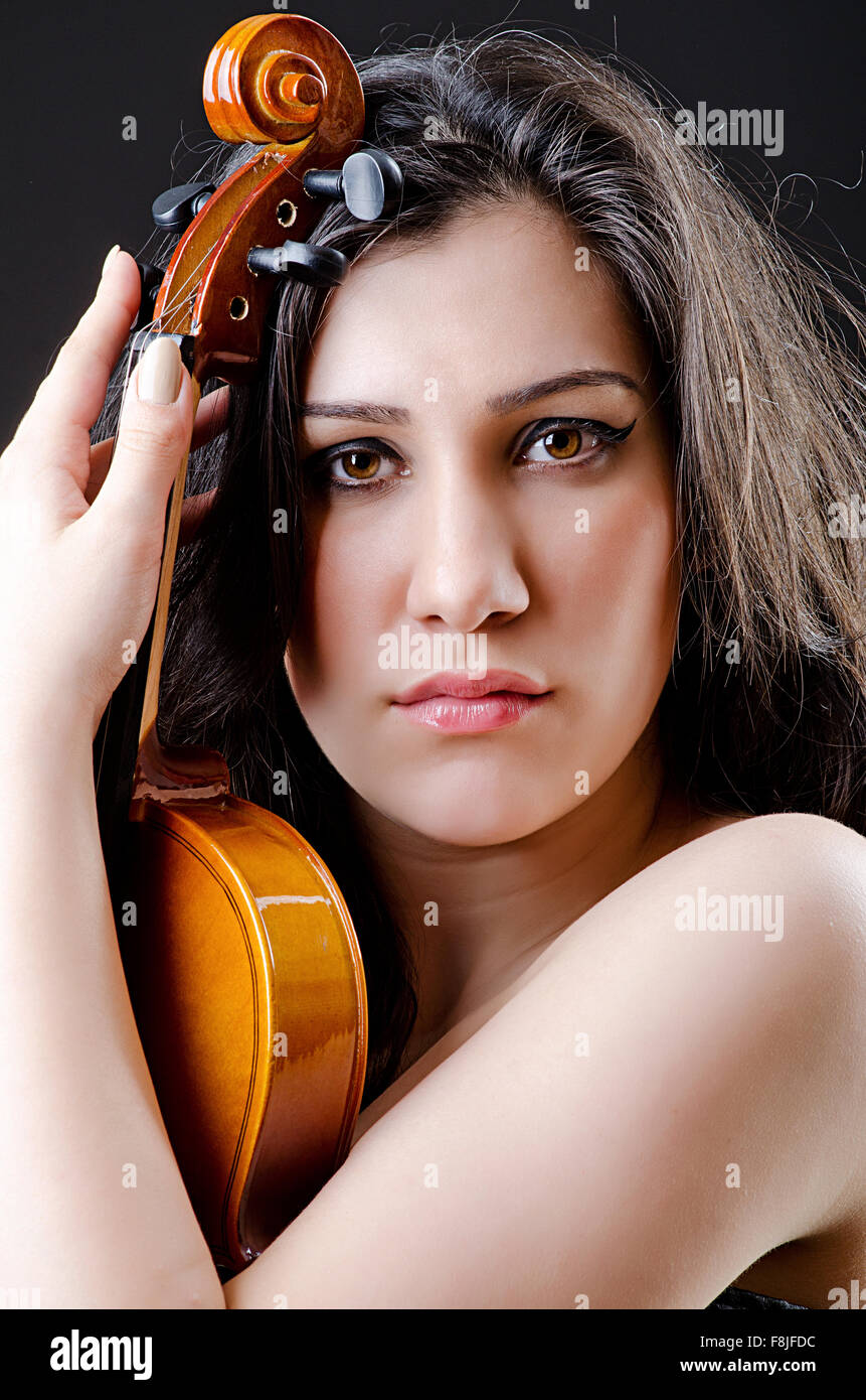 Female violin player against background Stock Photo - Alamy