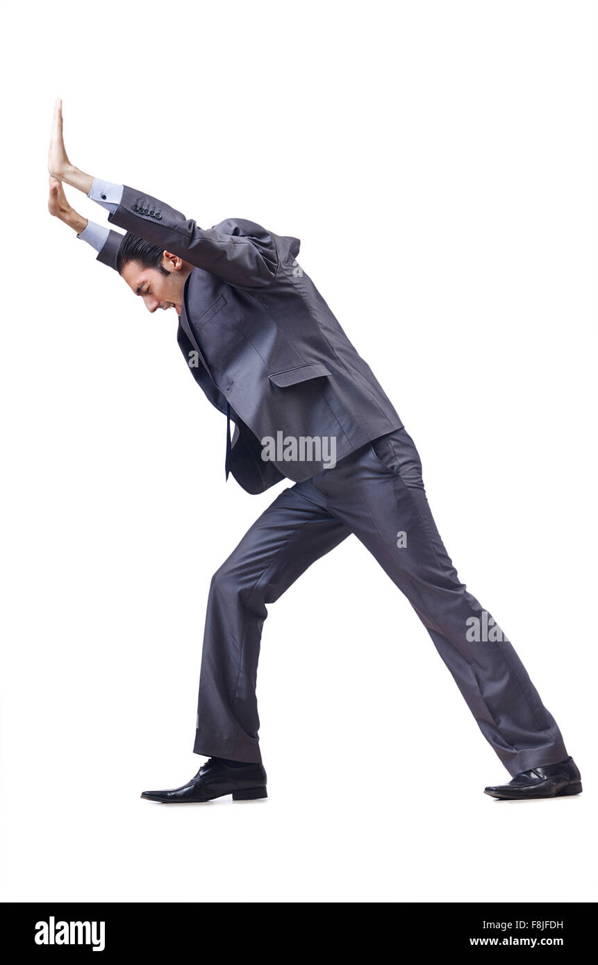 Young businessman pushing invisible obstacles Stock Photo - Alamy