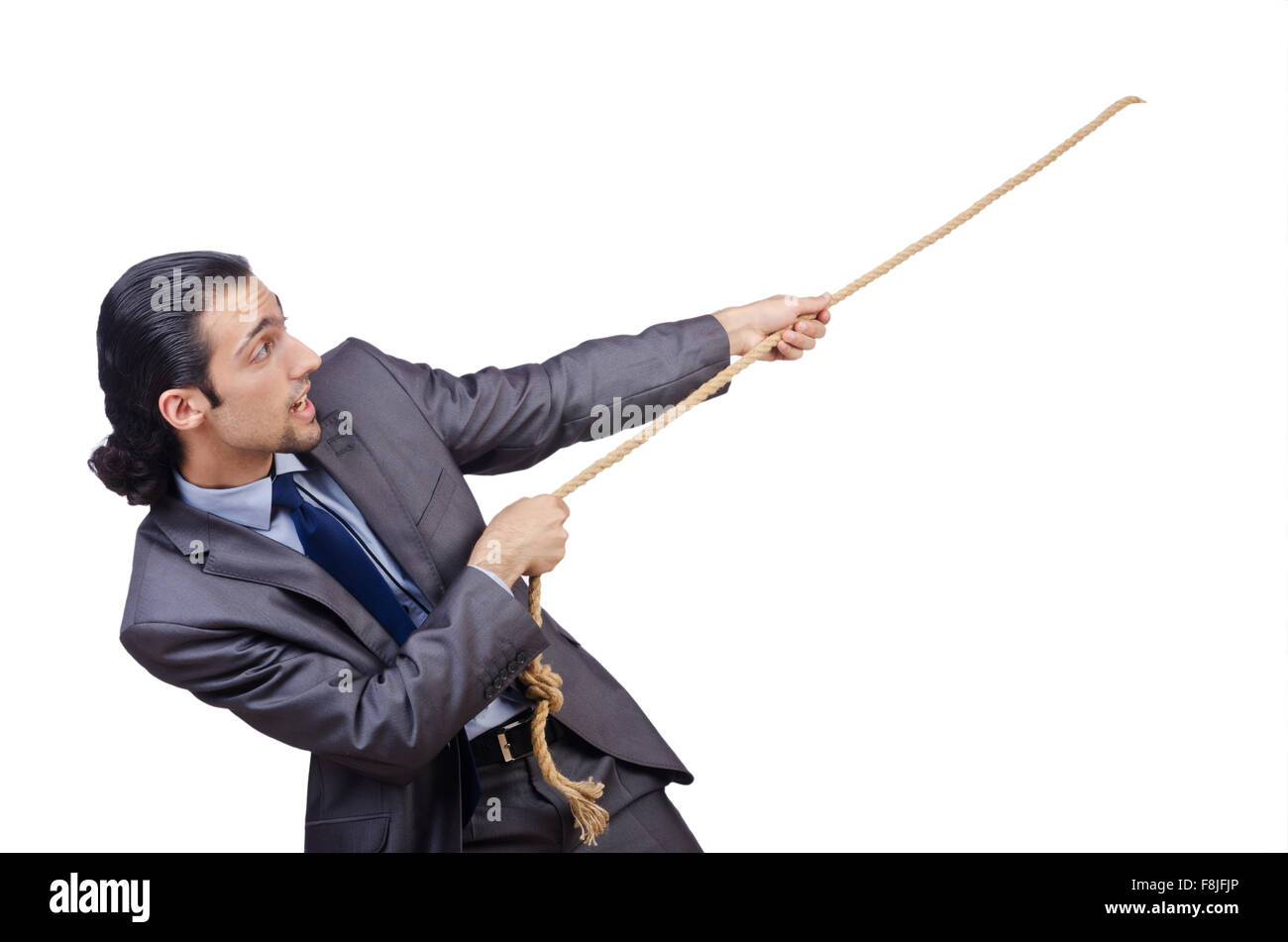 Businessman pulling rope on white Stock Photo - Alamy