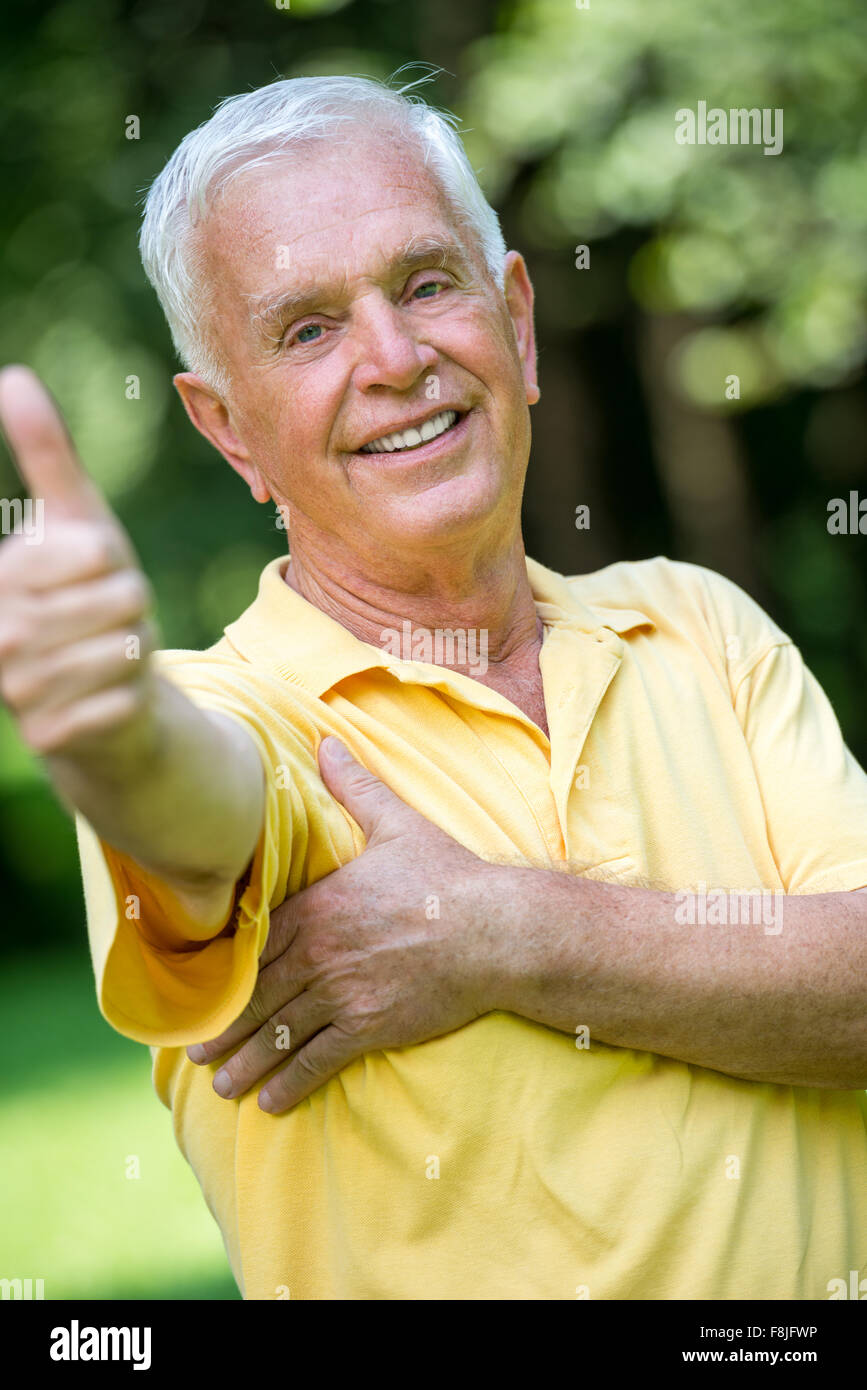 Portrait of smiling elderly man outdoor in park Stock Photo - Alamy