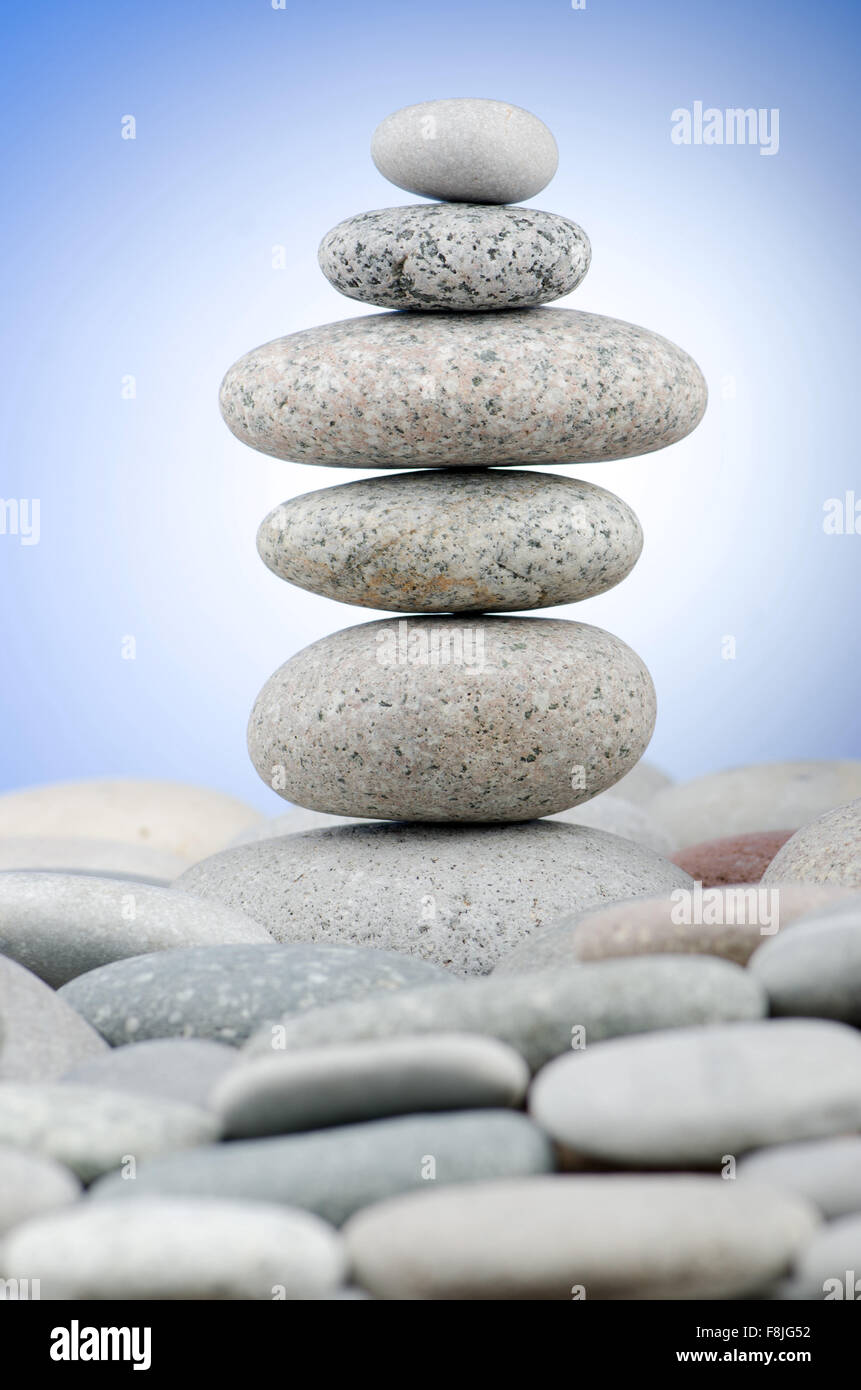 Pebbles stack against gradient background Stock Photo - Alamy