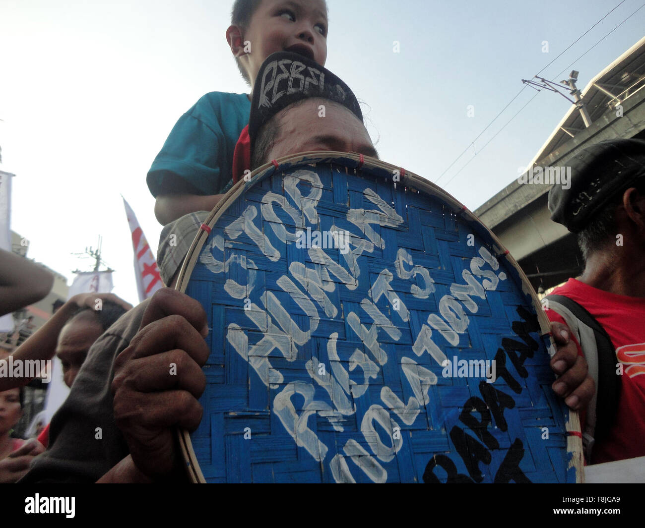 Manila, Philippines. 10th Dec, 2015. A Filipino protester carries a ...