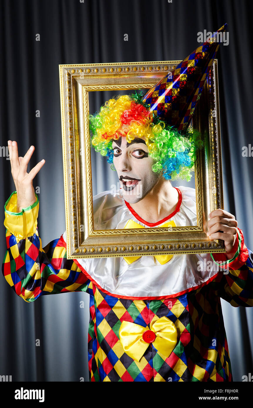 Clown with picture frames in studio Stock Photo - Alamy