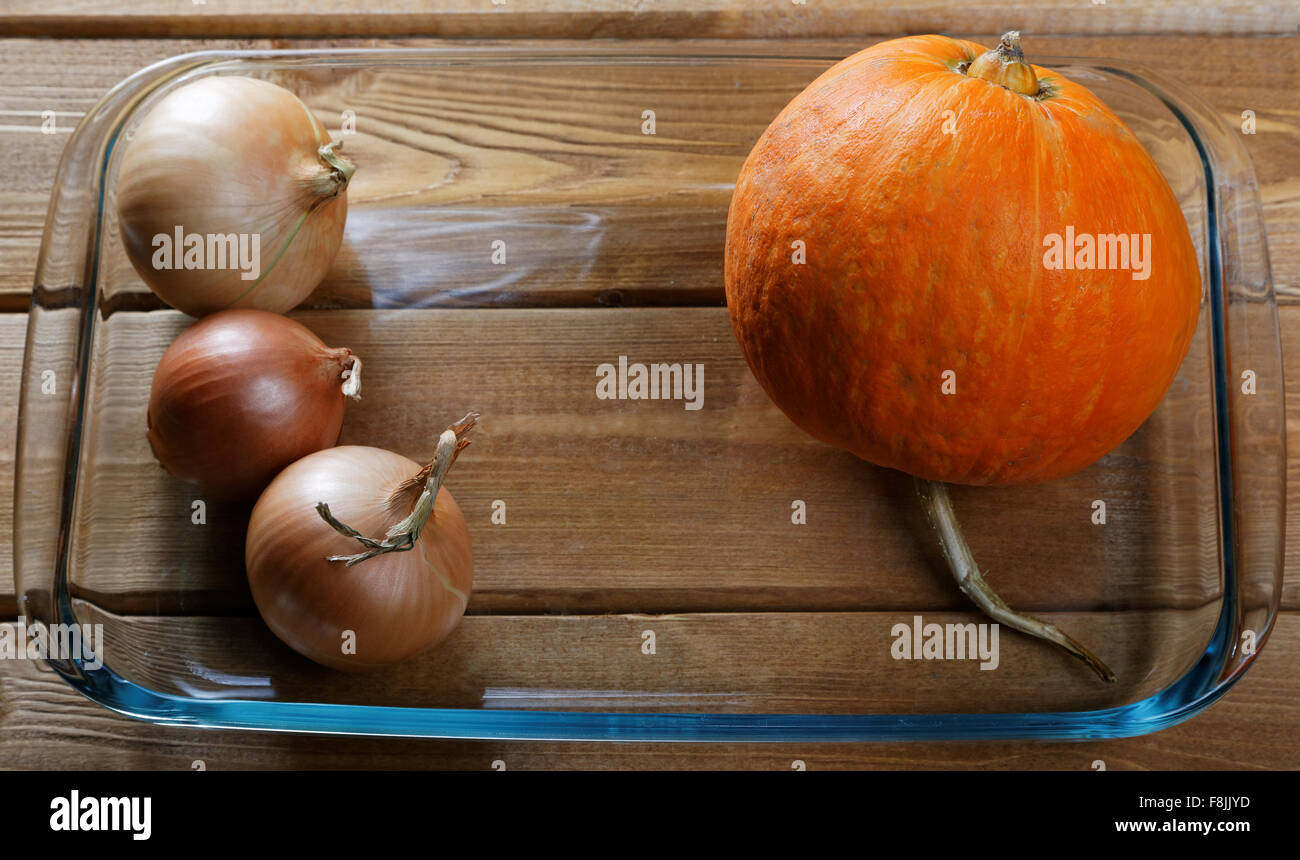 Small pumpkin and onions in a glass plate Stock Photo - Alamy