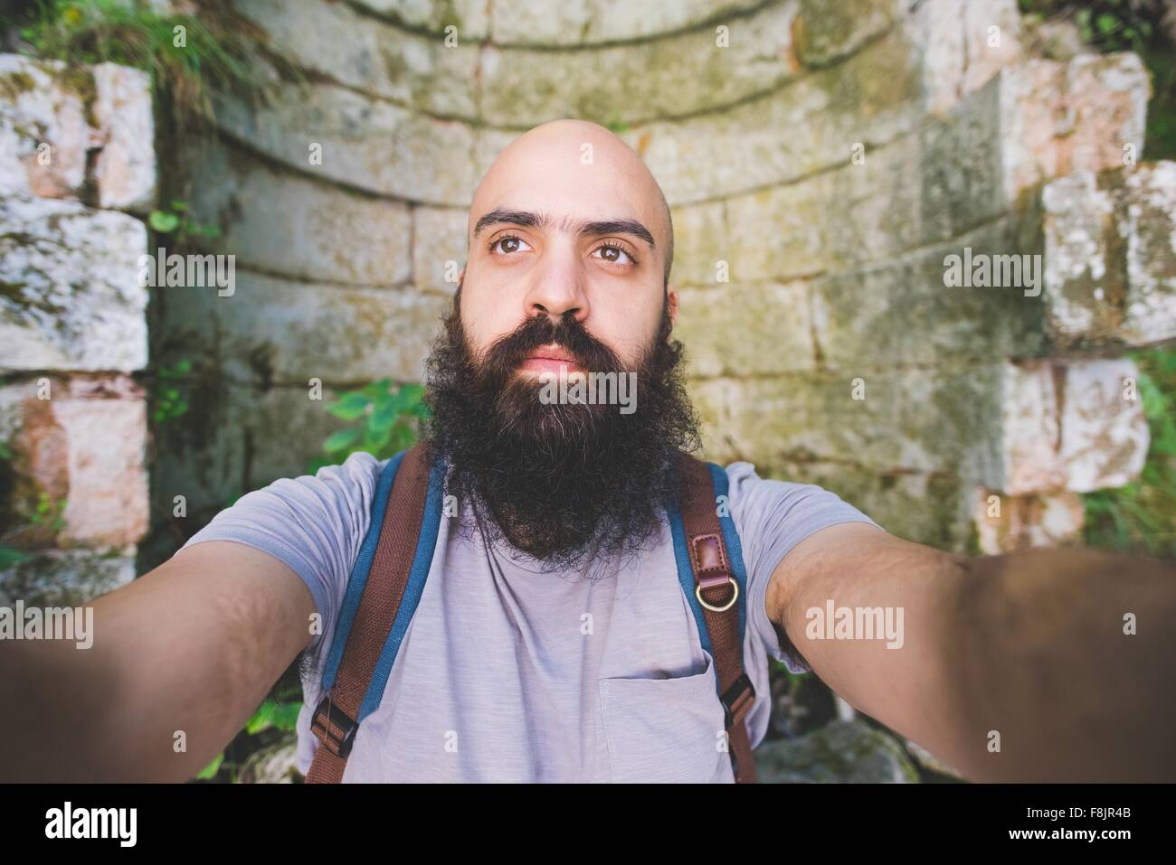 Bearded man posing against old brick wall, Garda, Italy Stock Photo - Alamy