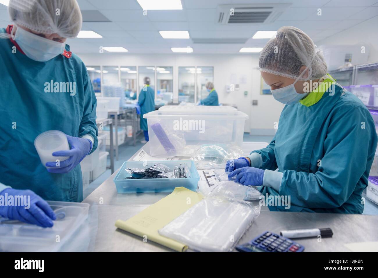 Workers packing surgical instruments in clean room of surgical ...