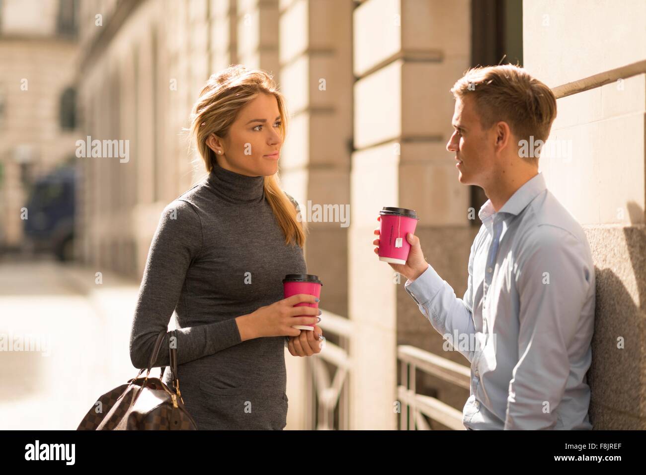 Businessman and businesswoman on coffee break, London, UK Stock Photo ...