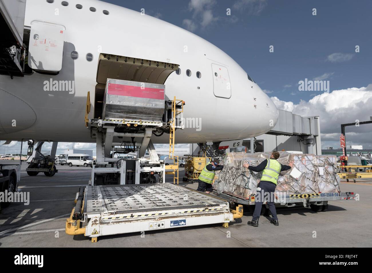 Ground crew loading freight into A380 aircraft Stock Photo - Alamy
