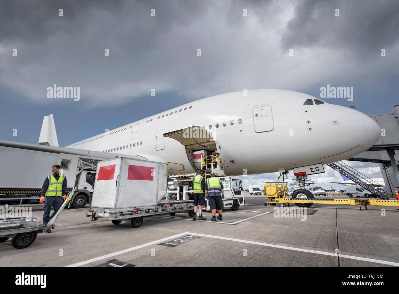 Ground crew loading freight onto A380 aircraft Stock Photo - Alamy