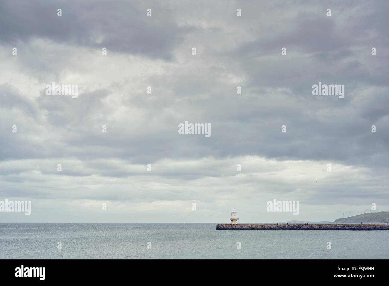 Distant view of harbour wall, Cumbria, UK Stock Photo - Alamy