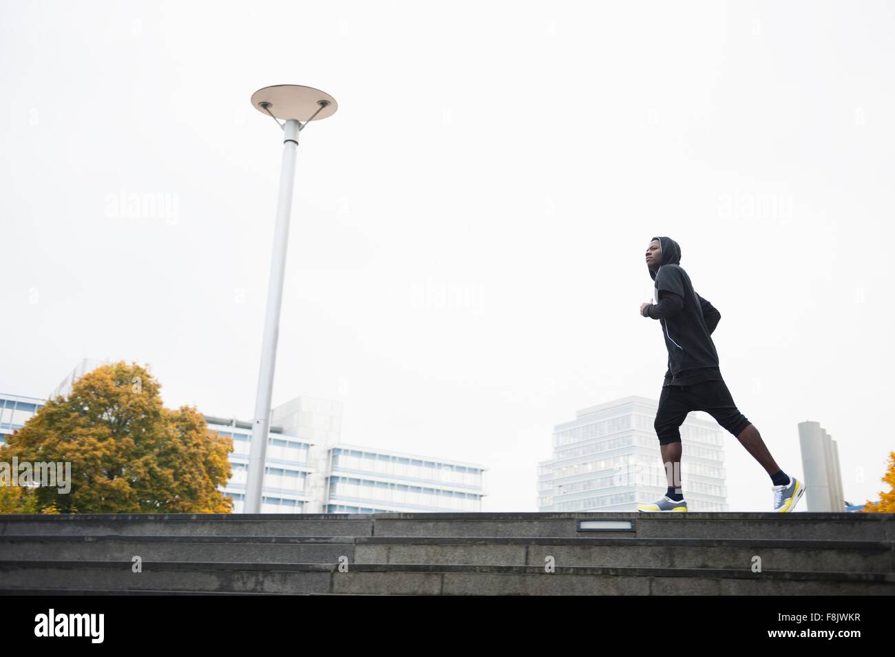 Young man running outdoors, low angle view Stock Photo - Alamy