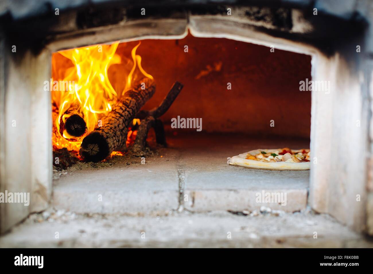 Pizza in traditional pizza wood oven Stock Photo - Alamy