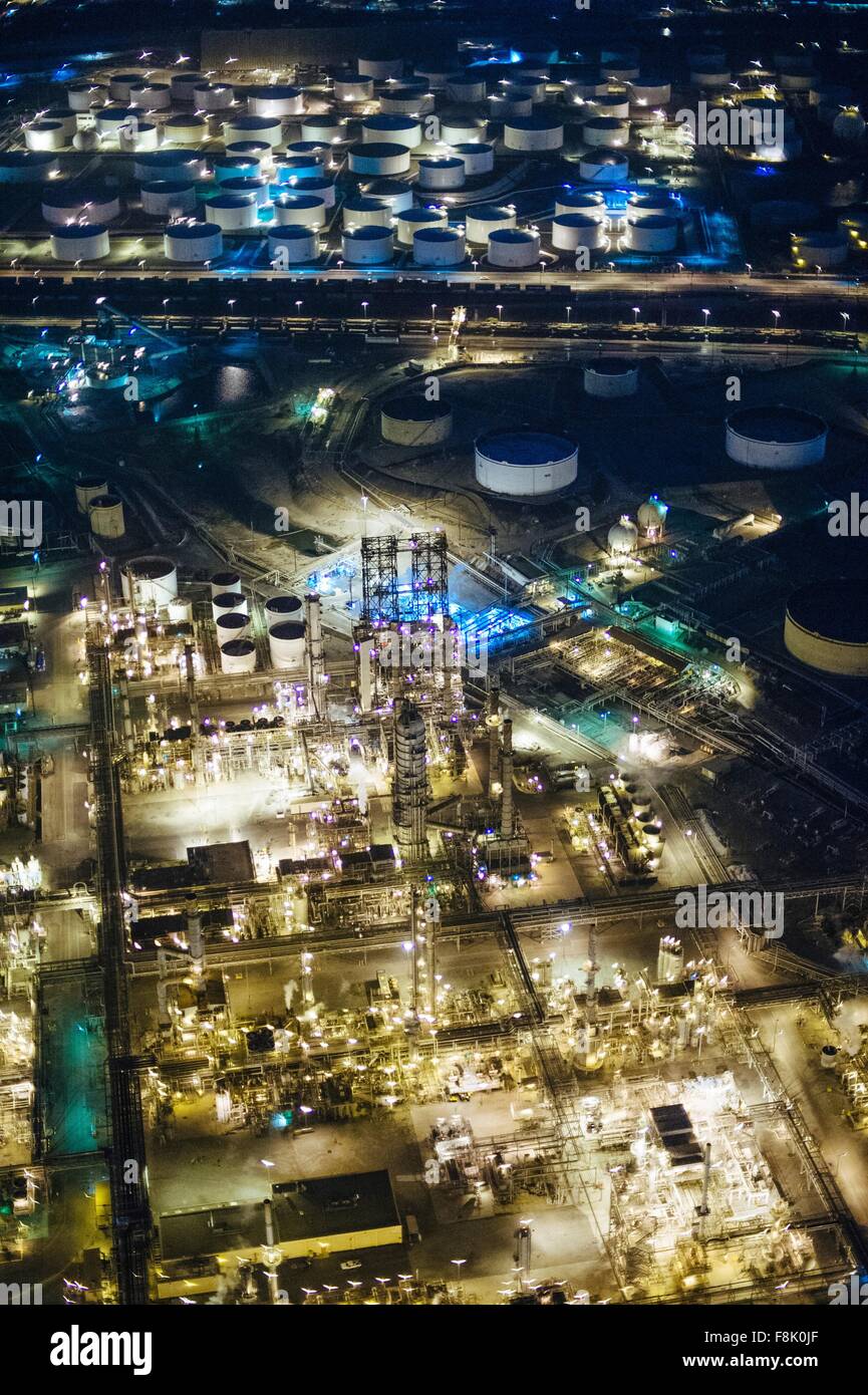 Aerial view of oil refinery and storage tanks illuminated at night, Los ...