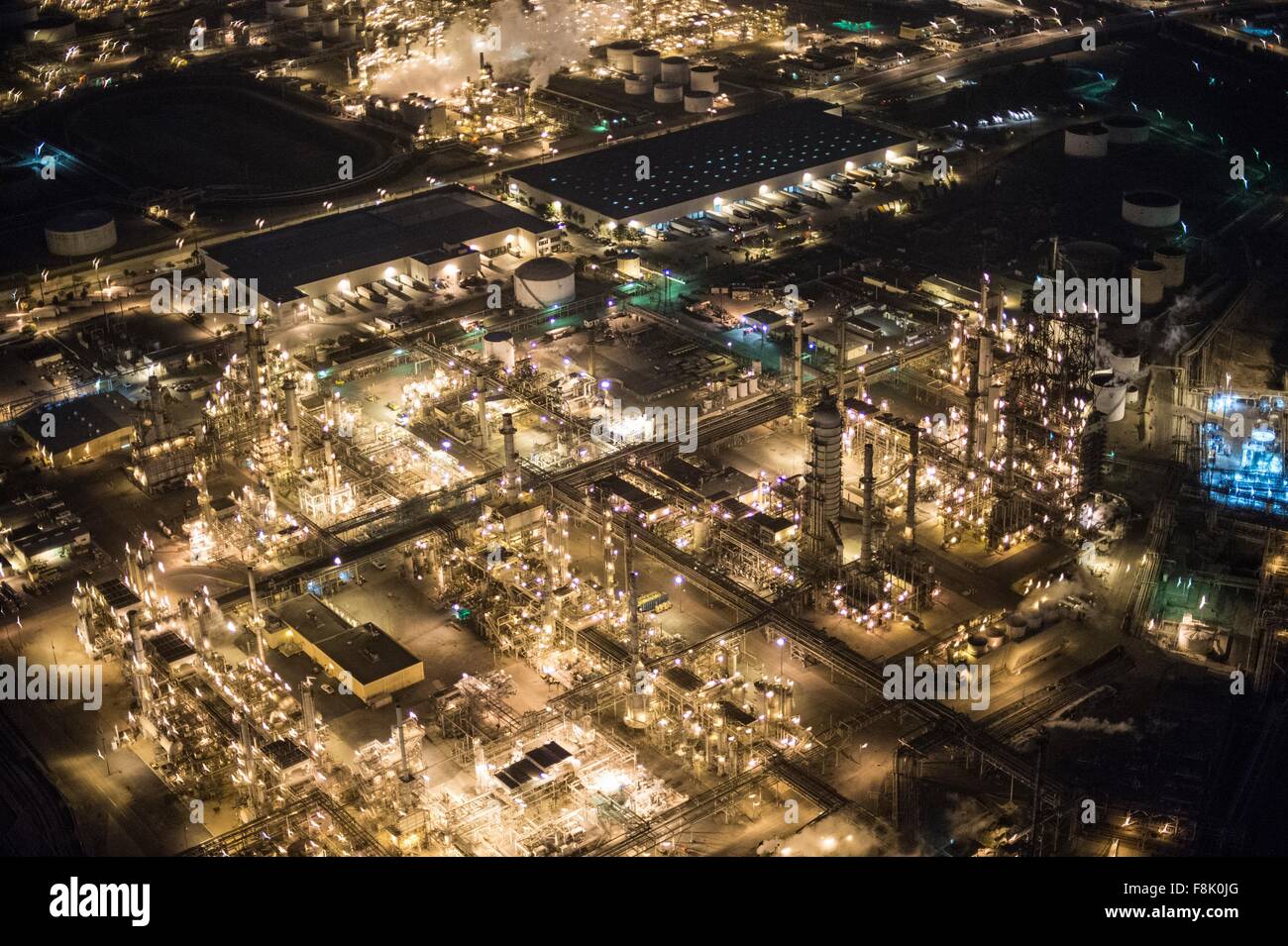 Aerial view of oil refinery illuminated at night, Los Angeles ...