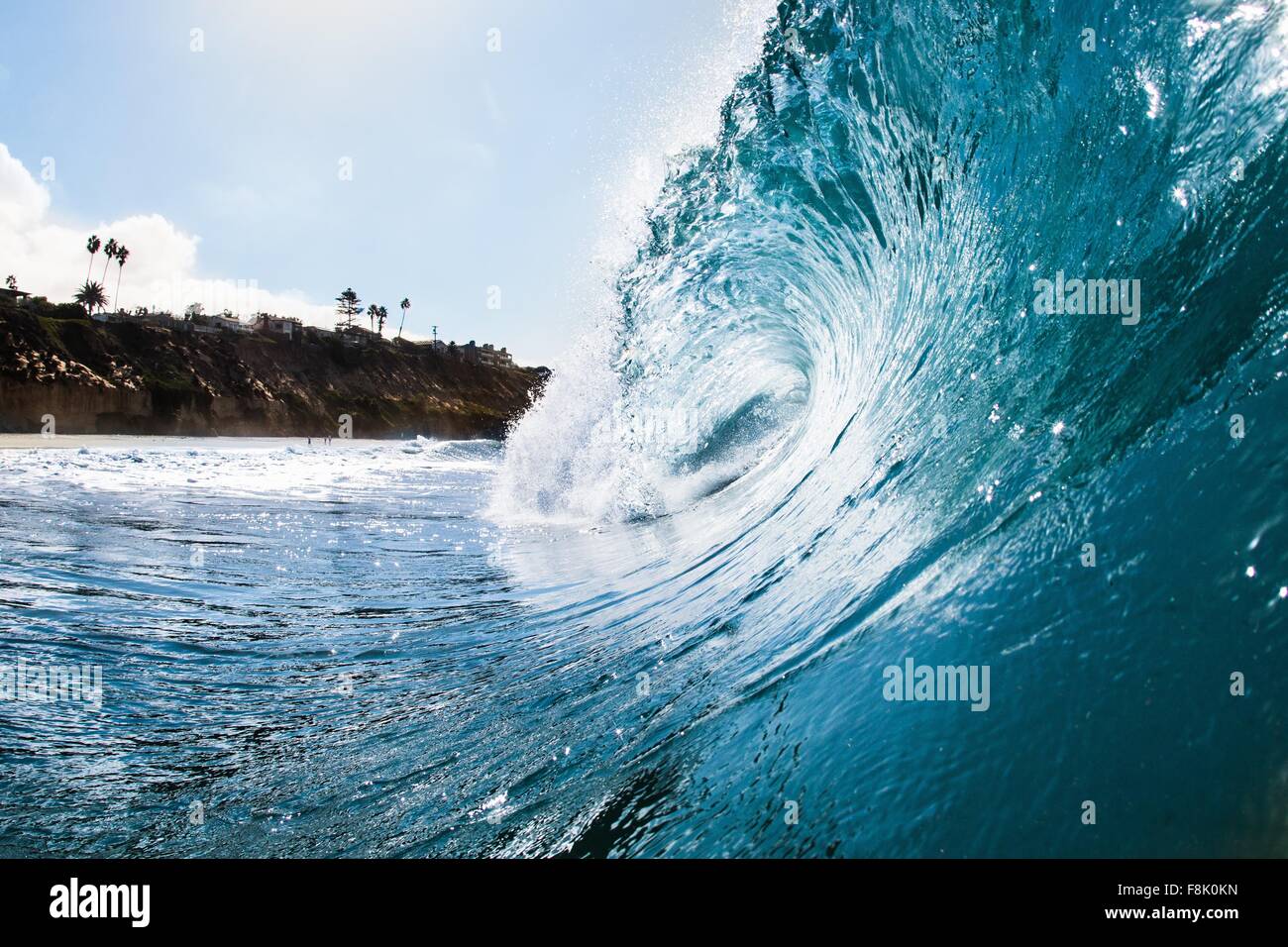 Surface level view of rolling ocean wave and coastline. Encinitas ...