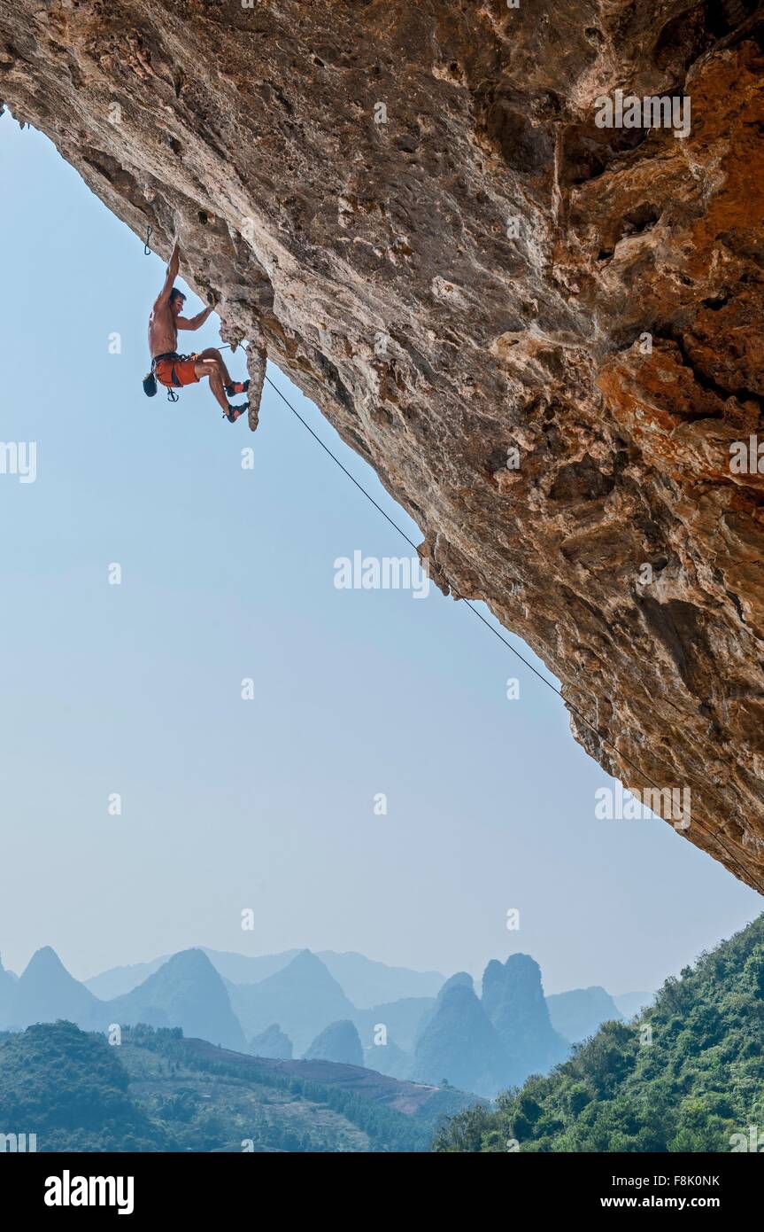 Male climber climbing at Odin's Den next to Moon Hill in Yangshuo ...