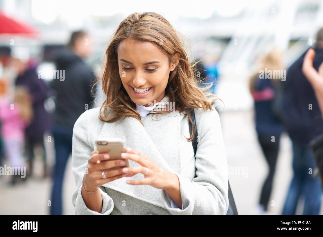 Young woman texts on smartphone hi-res stock photography and images - Alamy
