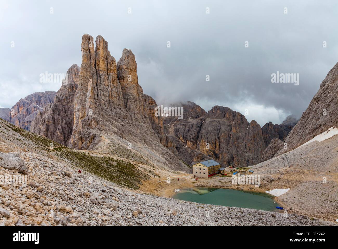 Industrial building and lake in valley, Dolomites, Italy Stock Photo ...