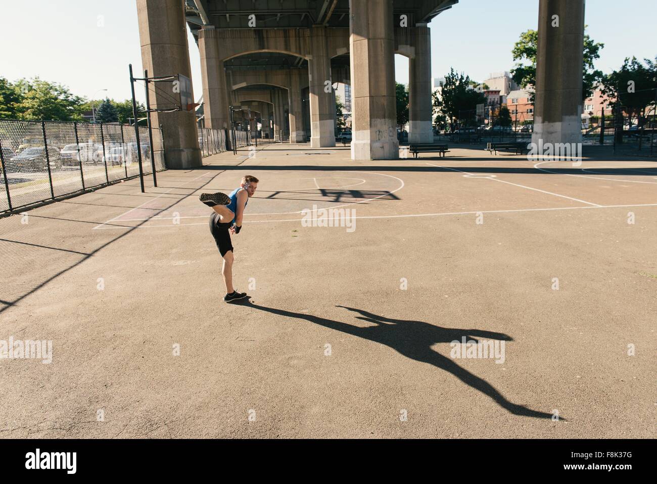 Young man outdoors, exercising on sports pitch Stock Photo - Alamy